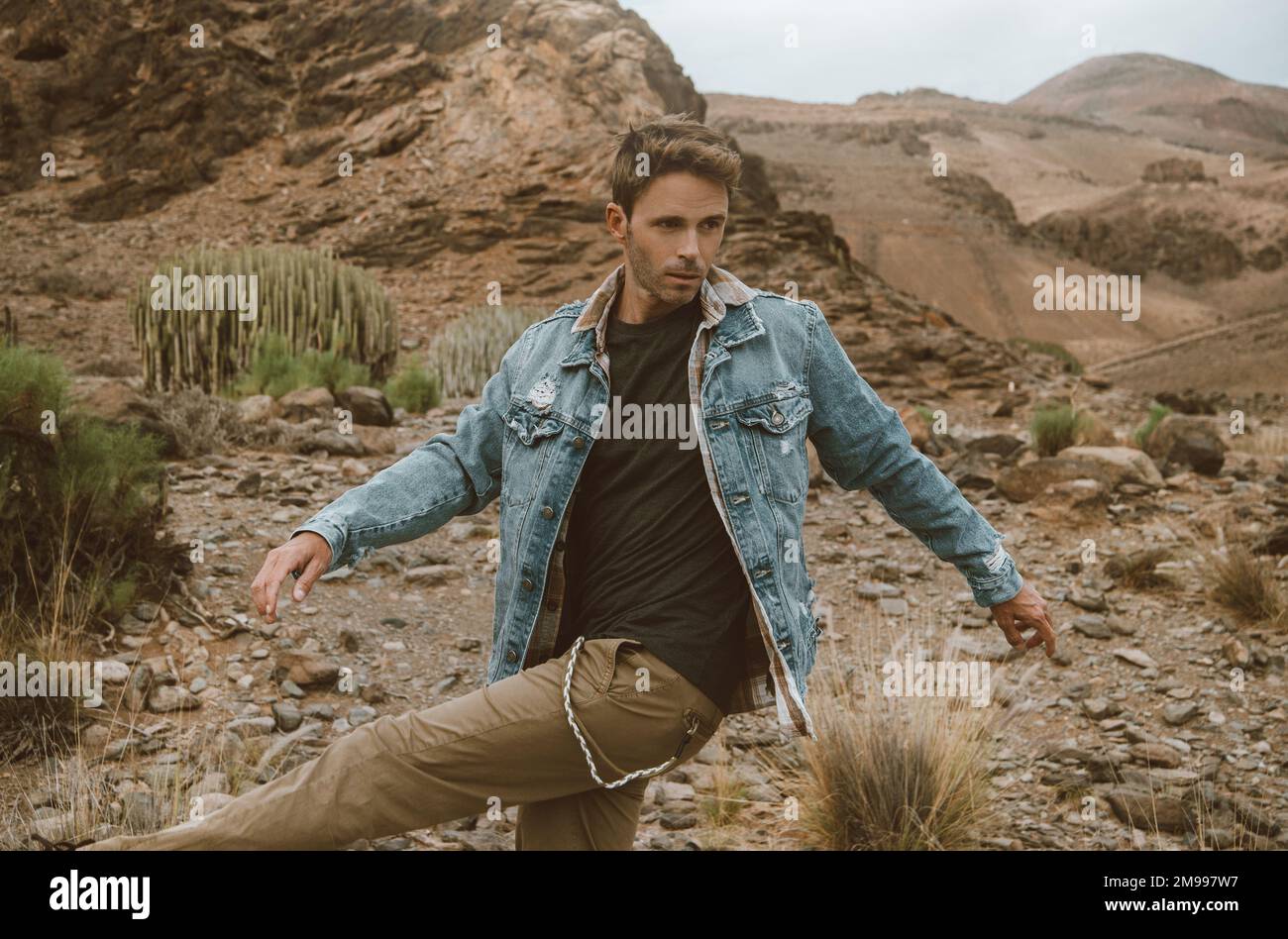 Young bearded man is walking on a wild west country road Stock Photo ...