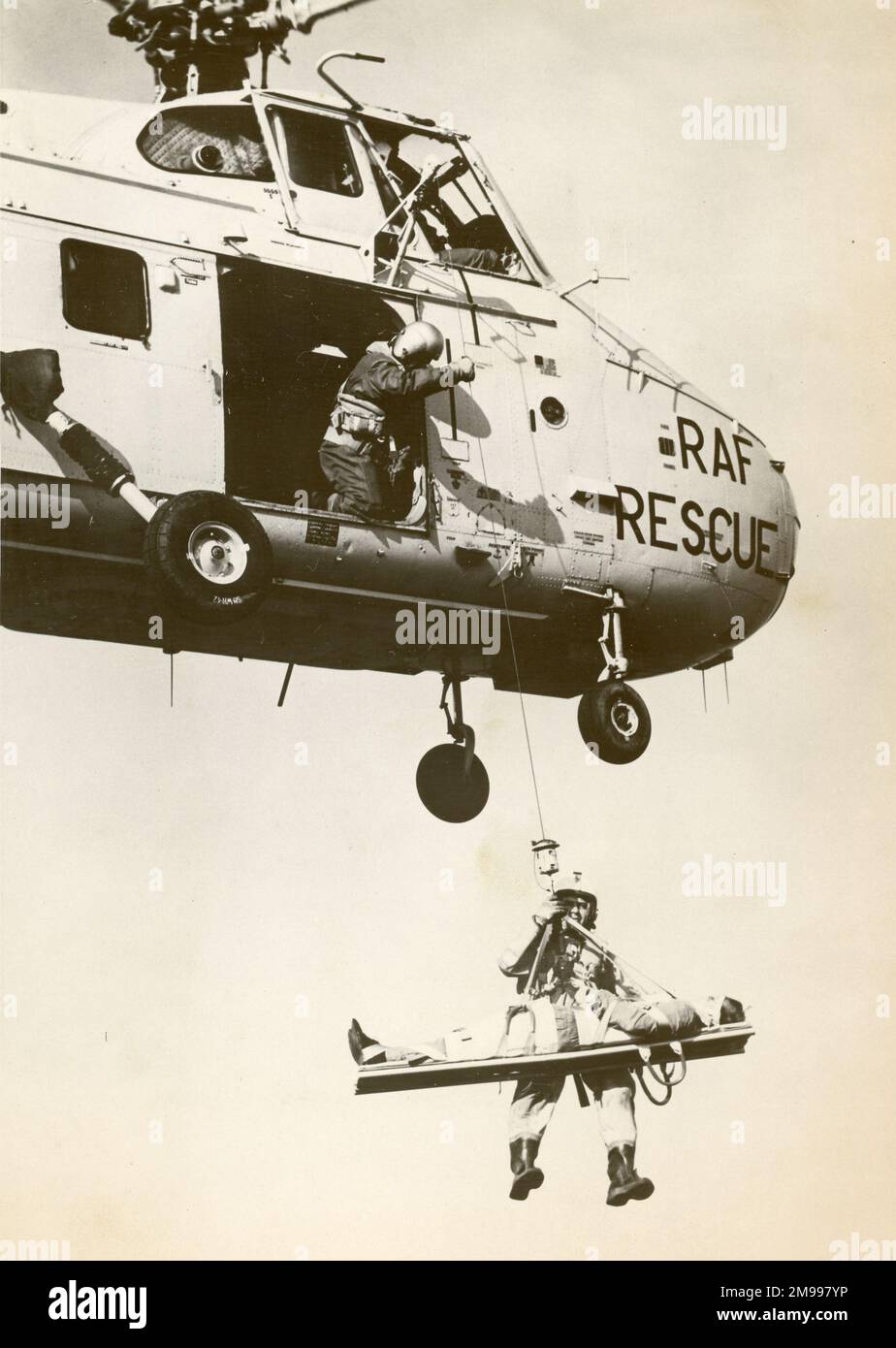 A Royal Air Force Westland Whirlwind winches aboard a stretcher Stock ...