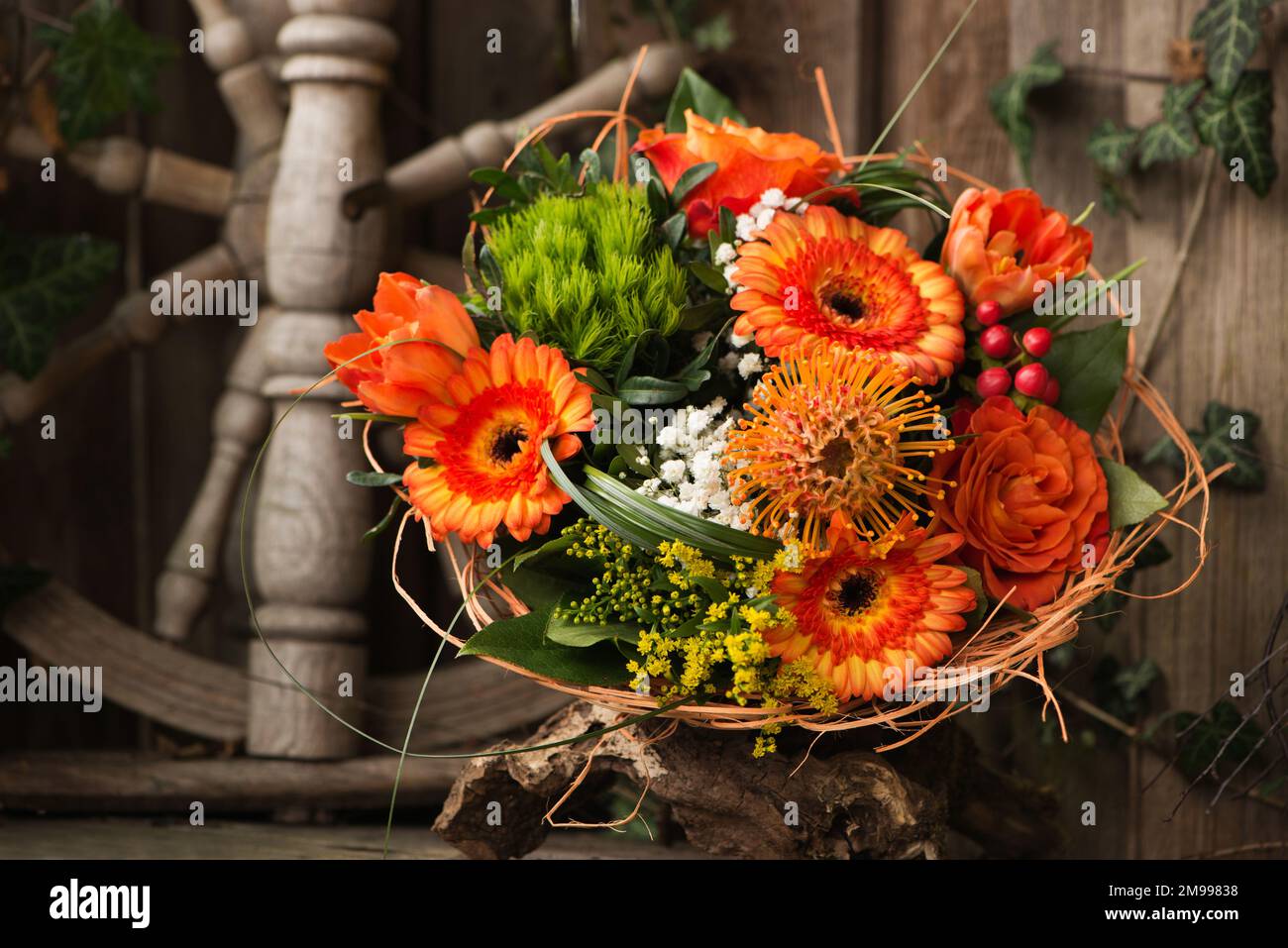 Colorful flower boquet with old wooden spinning wheel Stock Photo - Alamy
