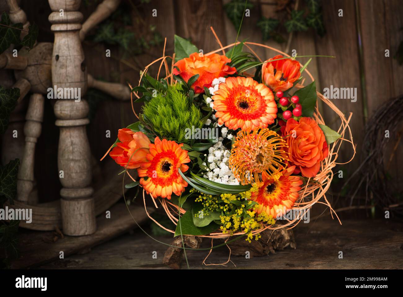 Colorful flower boquet with old wooden spinning wheel Stock Photo - Alamy