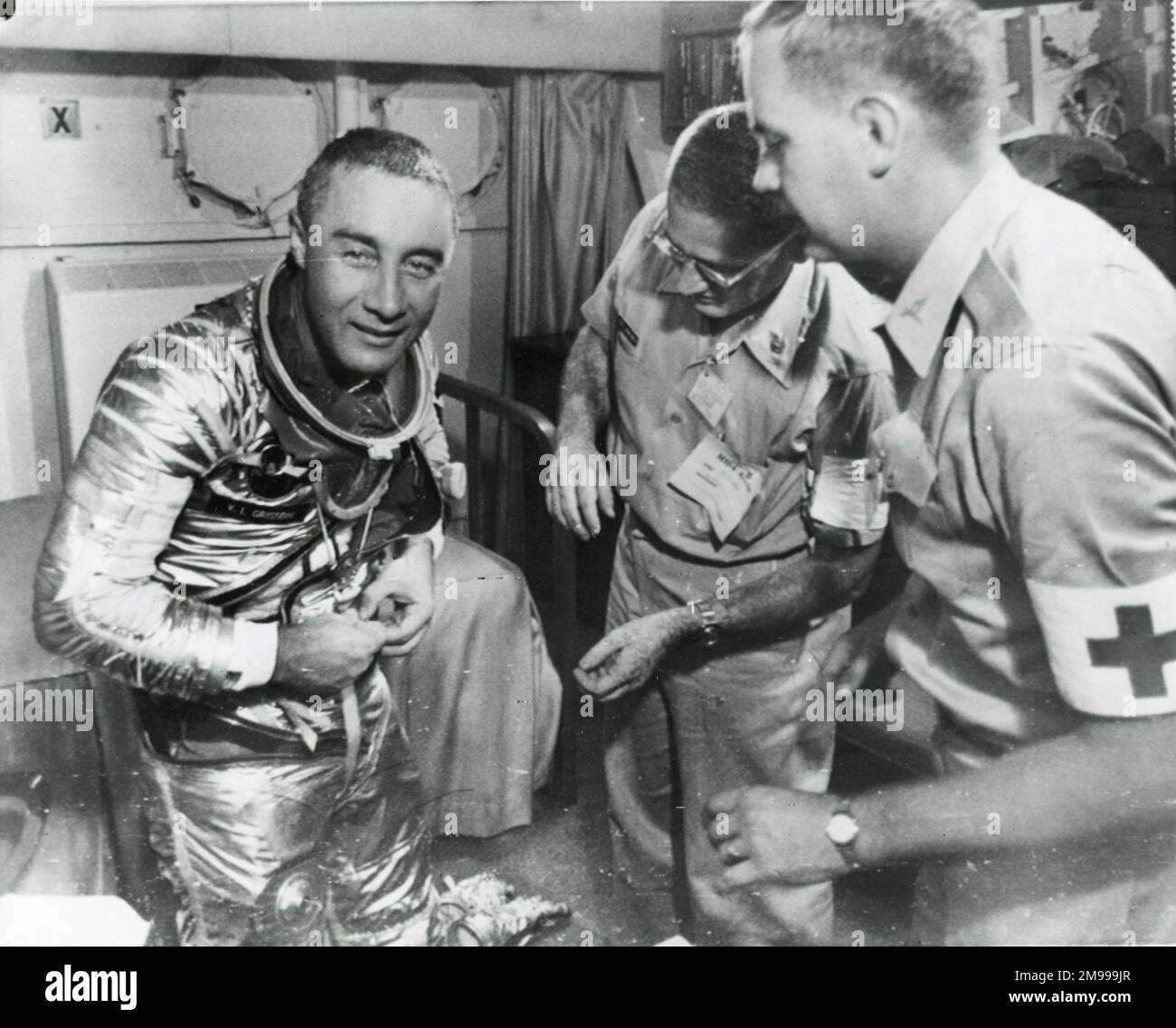 Astronaut Virgil ?Gus? Grissom starts to remove his spacesuit prior to ...