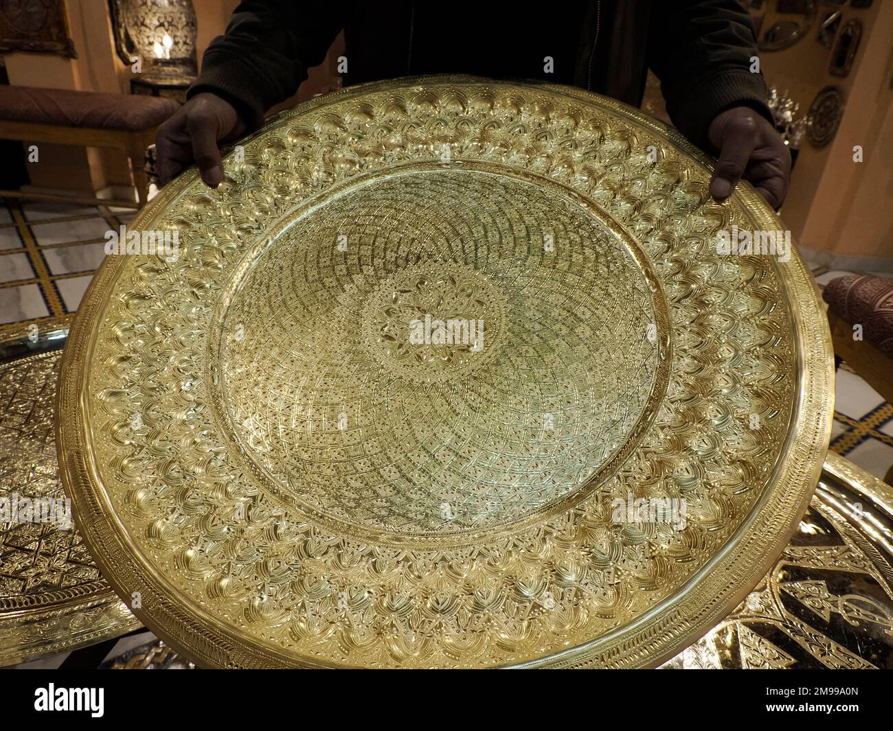Metal craftsman making copper trays in Fes Morocco Stock Photo - Alamy