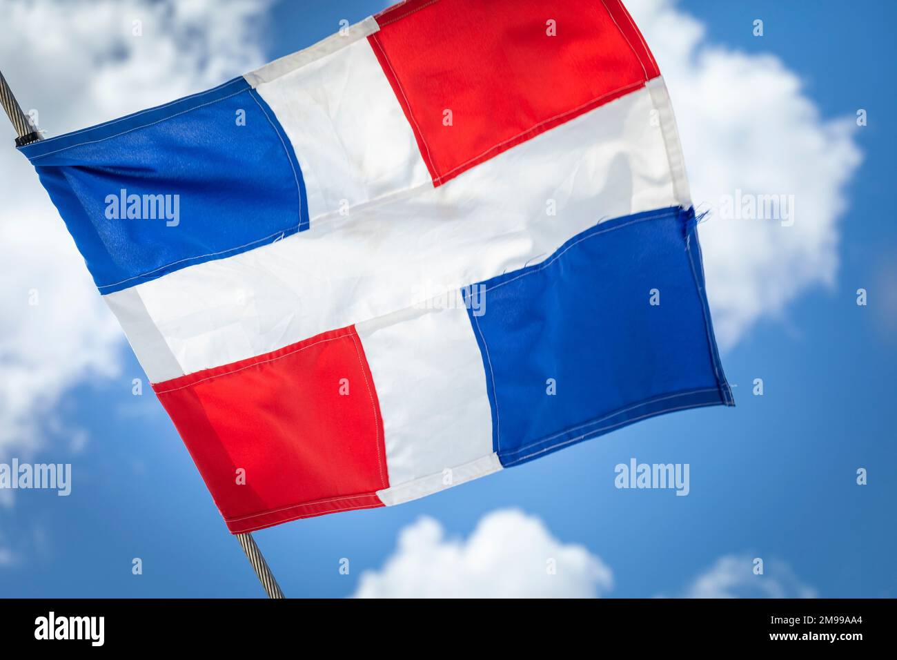 Dominican Republic National Flag Waving against sunny blue sky in Punta ...