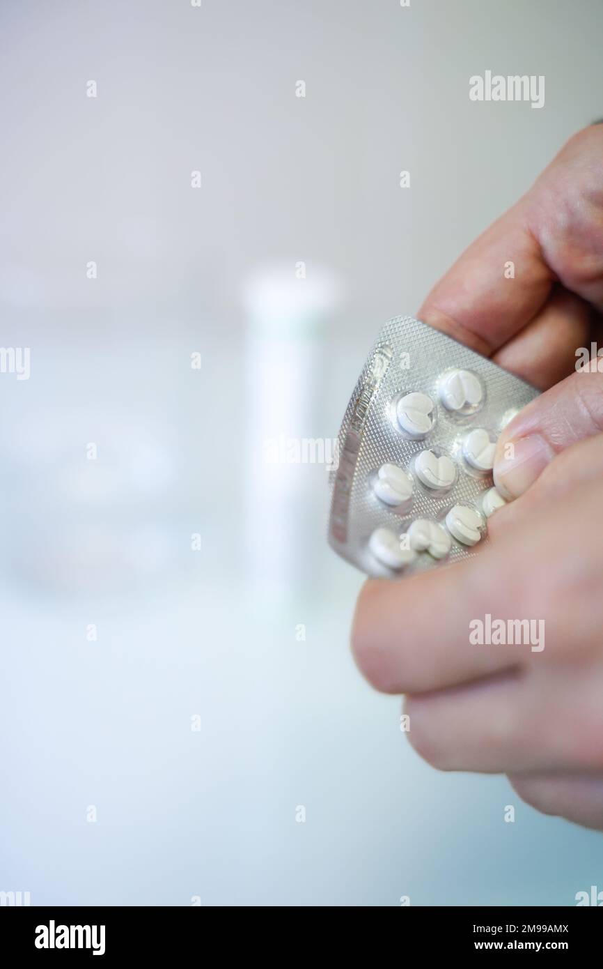 a person takes out a pill from the tablet with copy space. immunity to ...