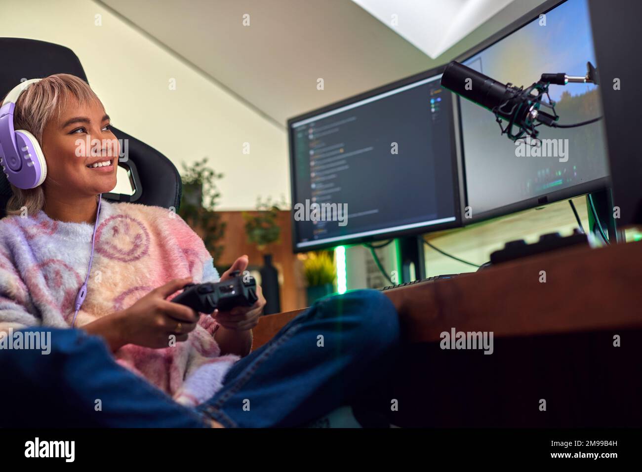 Woman With Controller Gaming At Home Sitting At Desk With Multiple ...