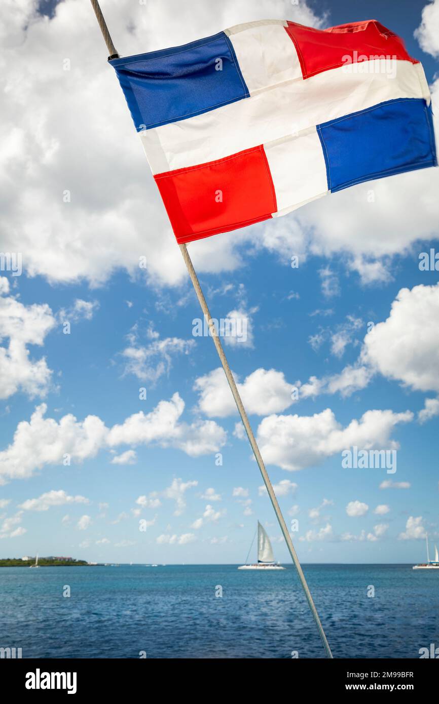 Dominican Republic National Flag Waving against sunny blue sky in Punta ...