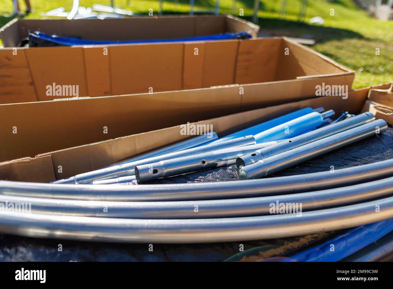 Large cardboard boxes with iron beams and other kit to assemble a ...