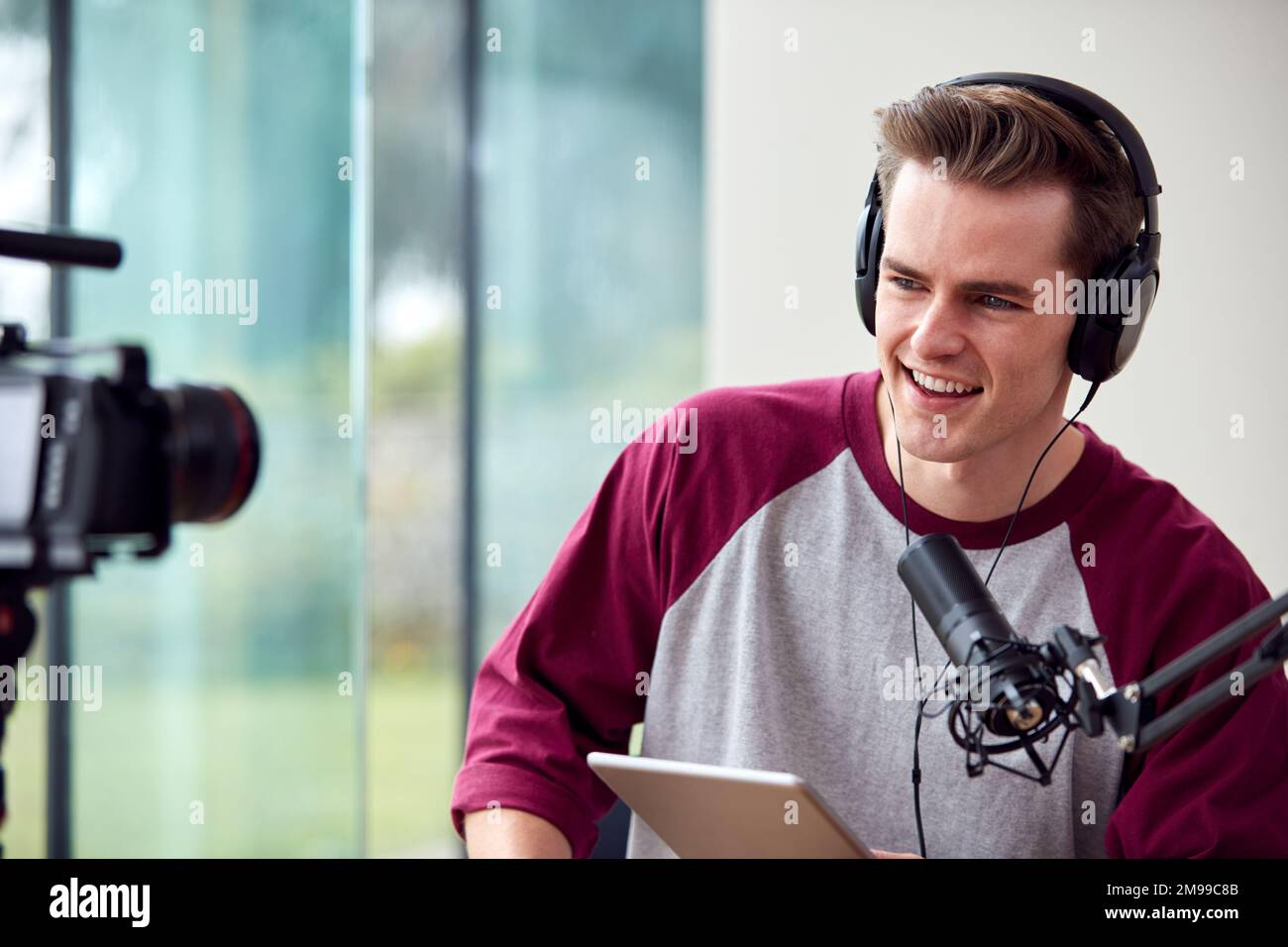 Male Vlogger With Digital Tablet Recording Video At Home With Camera ...