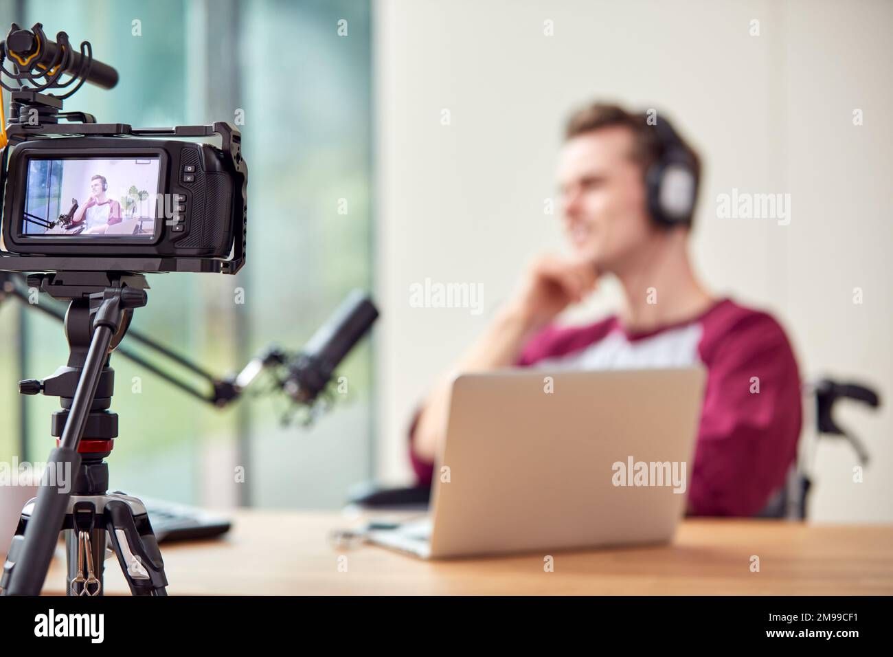 Male Vlogger With Laptop Recording Video At Home With Camera Stock ...