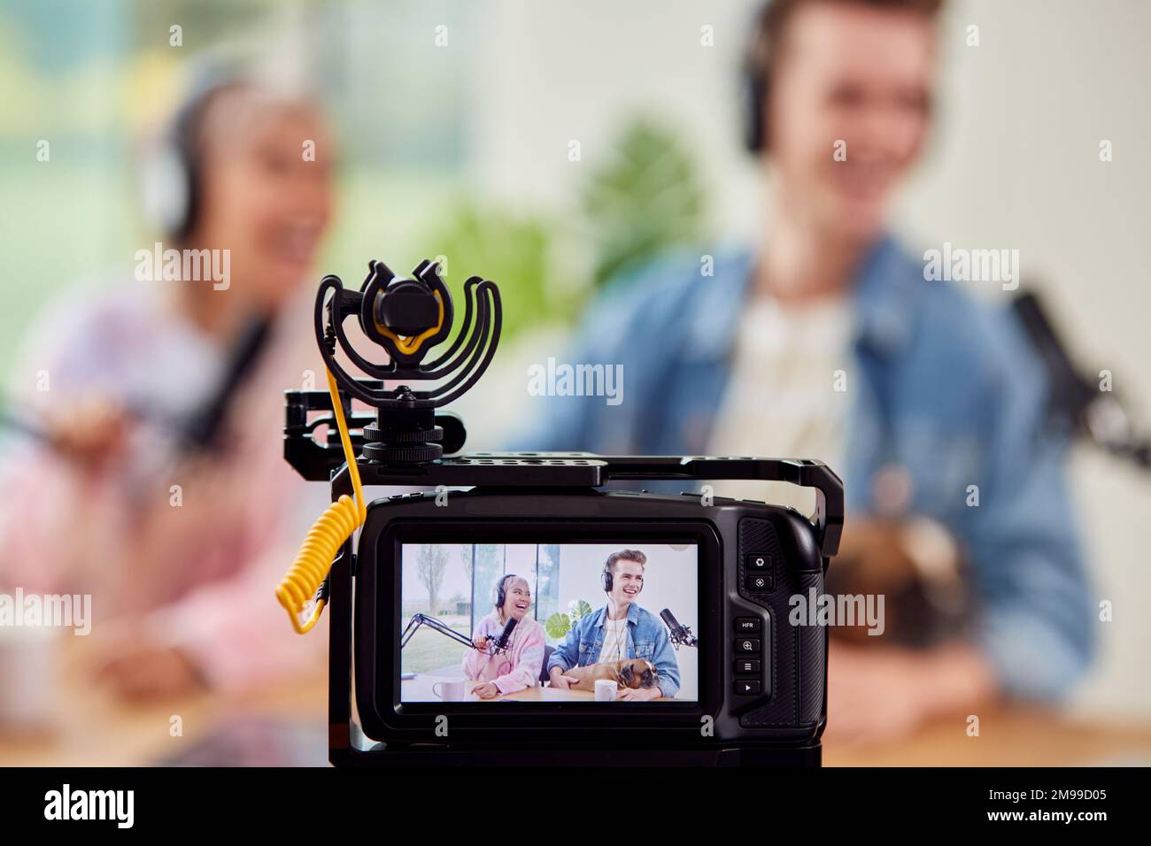 Couple With Dog Vlogging Recording Video At Home With Camera Stock ...