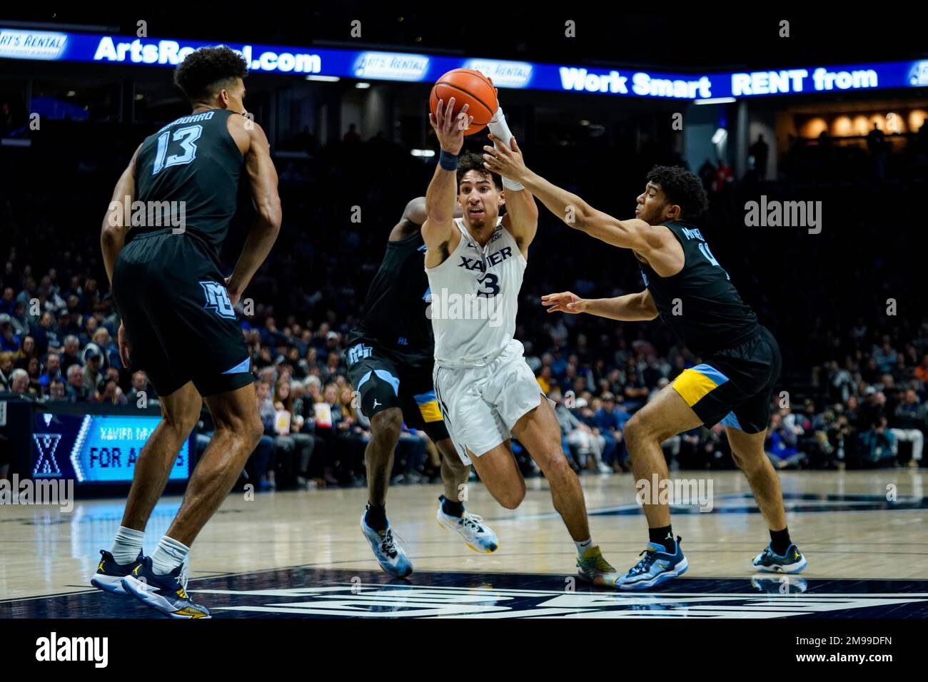 Xavier guard Colby Jones (3) drives against Marquette's Oso Ighodaro ...