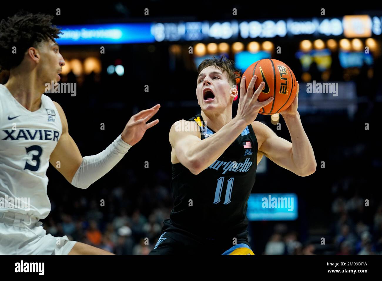 Marquette guard Tyler Kolek (11) drives against Xavier's Colby Jones (3 ...