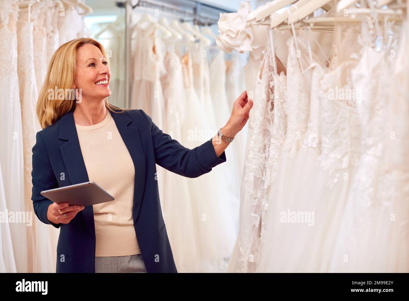 Female Owner Of Bridal Wedding Dress Shop With Digital Tablet Stock ...