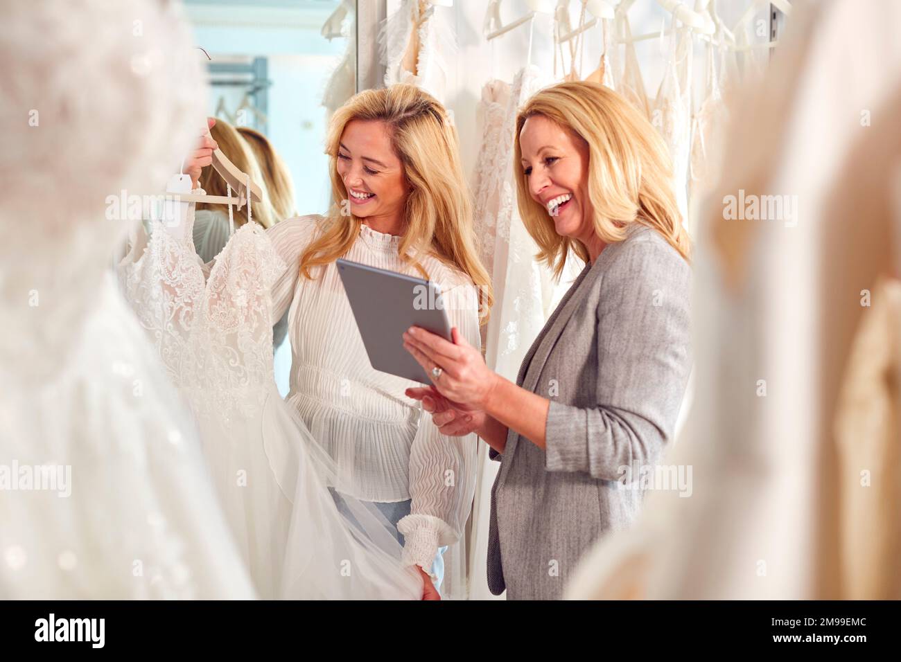 Female Customer With Owner Of Bridal Store Buying Or Choosing Wedding ...