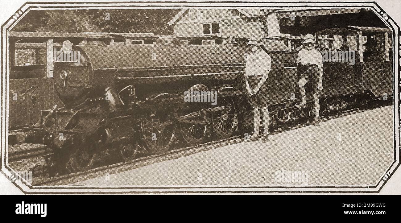 A 1930 view of two boys wearing short trousers and sun caps standing ...