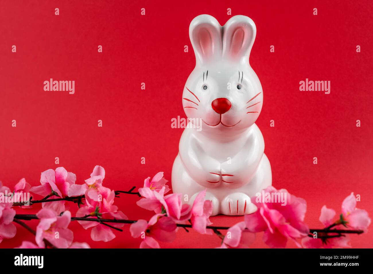 Rabbit coin bank Year of Rabbit concept and cherry blossom Stock Photo ...