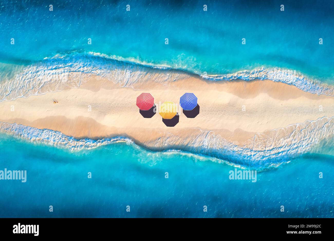 Aerial view of blue sea on both sides and beach with umbrellas Stock ...
