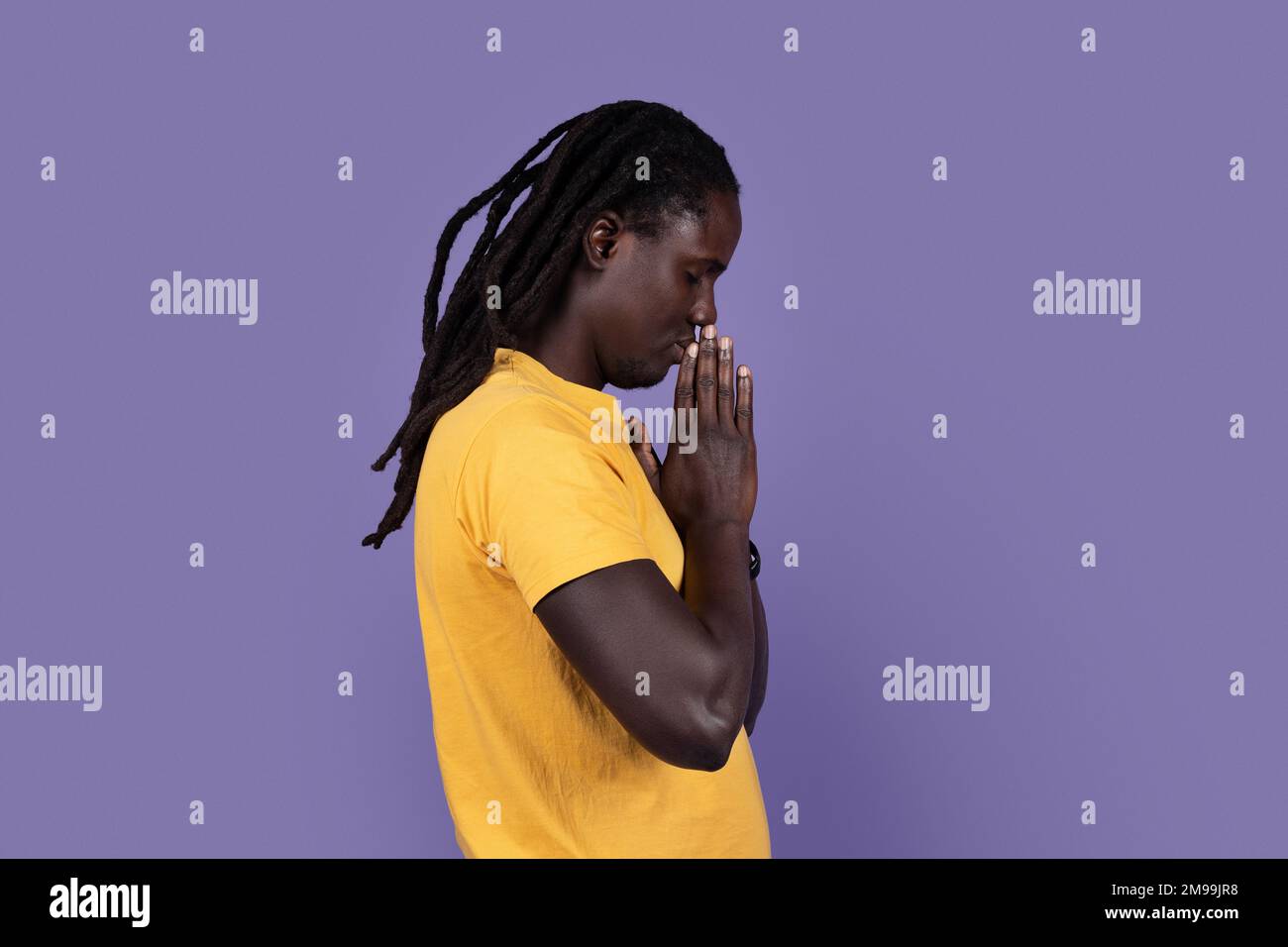 Man praying eyes closed holding hi-res stock photography and images - Alamy