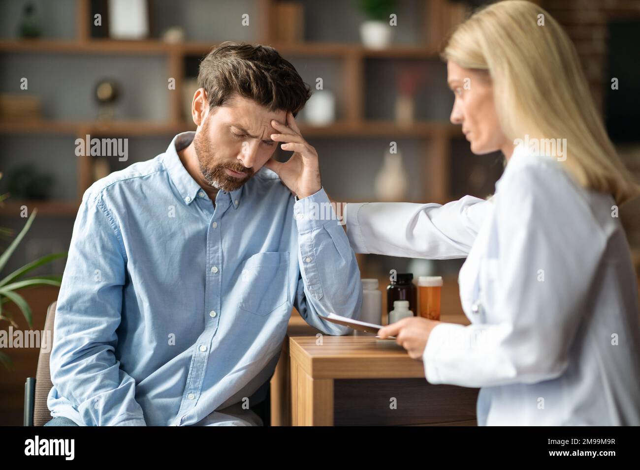 Bad Diagnosis. Doctor Lady Comforting Depressed Male Patient During ...
