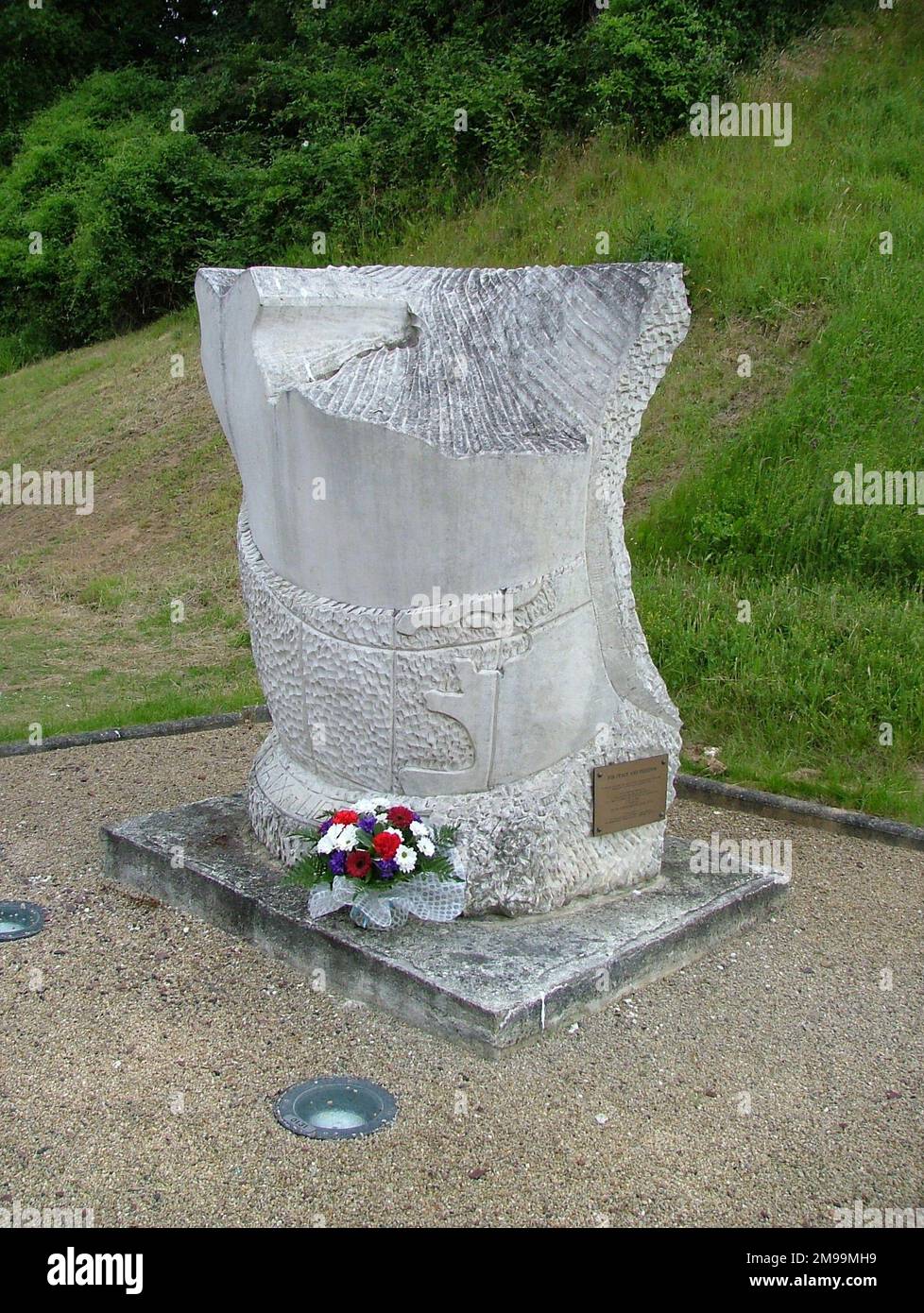 This truncated stone pillar has a simple bas-relief representation of ...