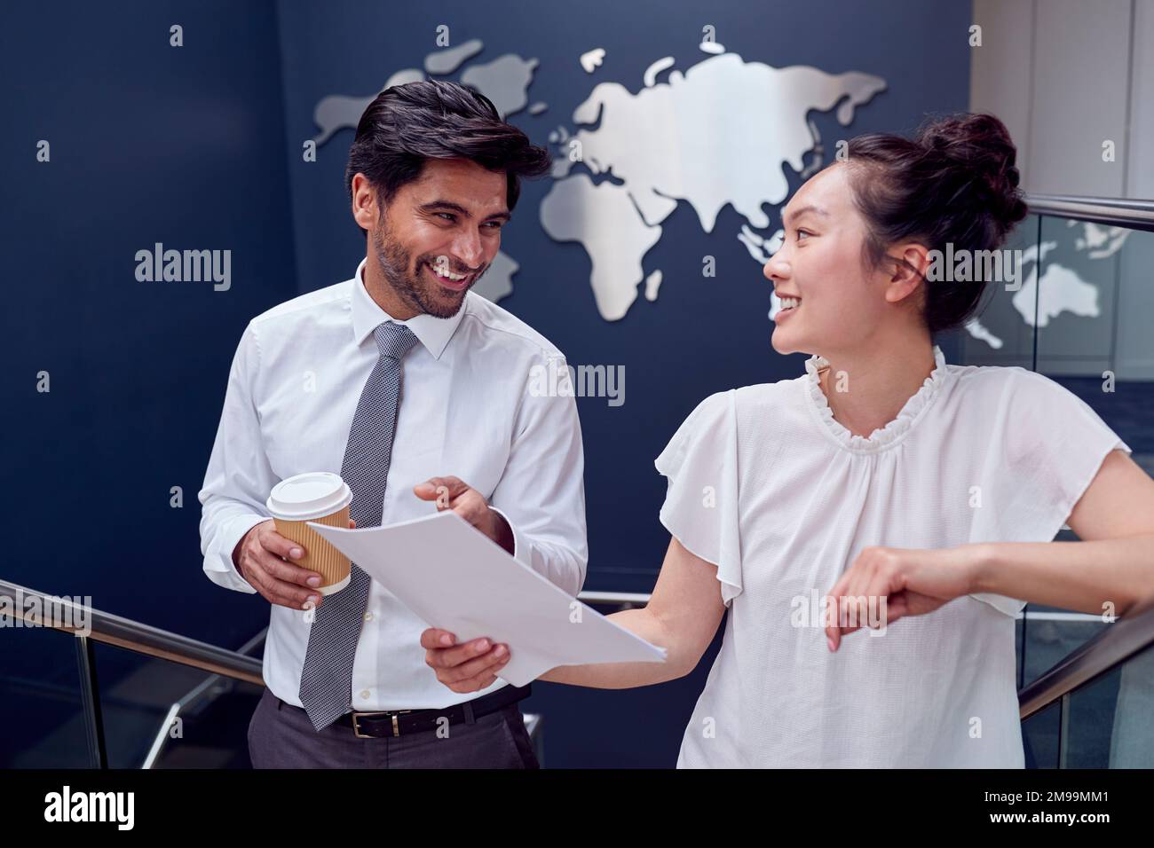 Two Business Colleagues Have Informal Meeting On Stairs Of Office With ...
