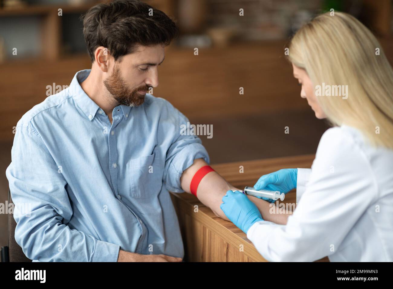 Therapist Lady With Syringe Doing Intravenous Medicine Shot To Male ...