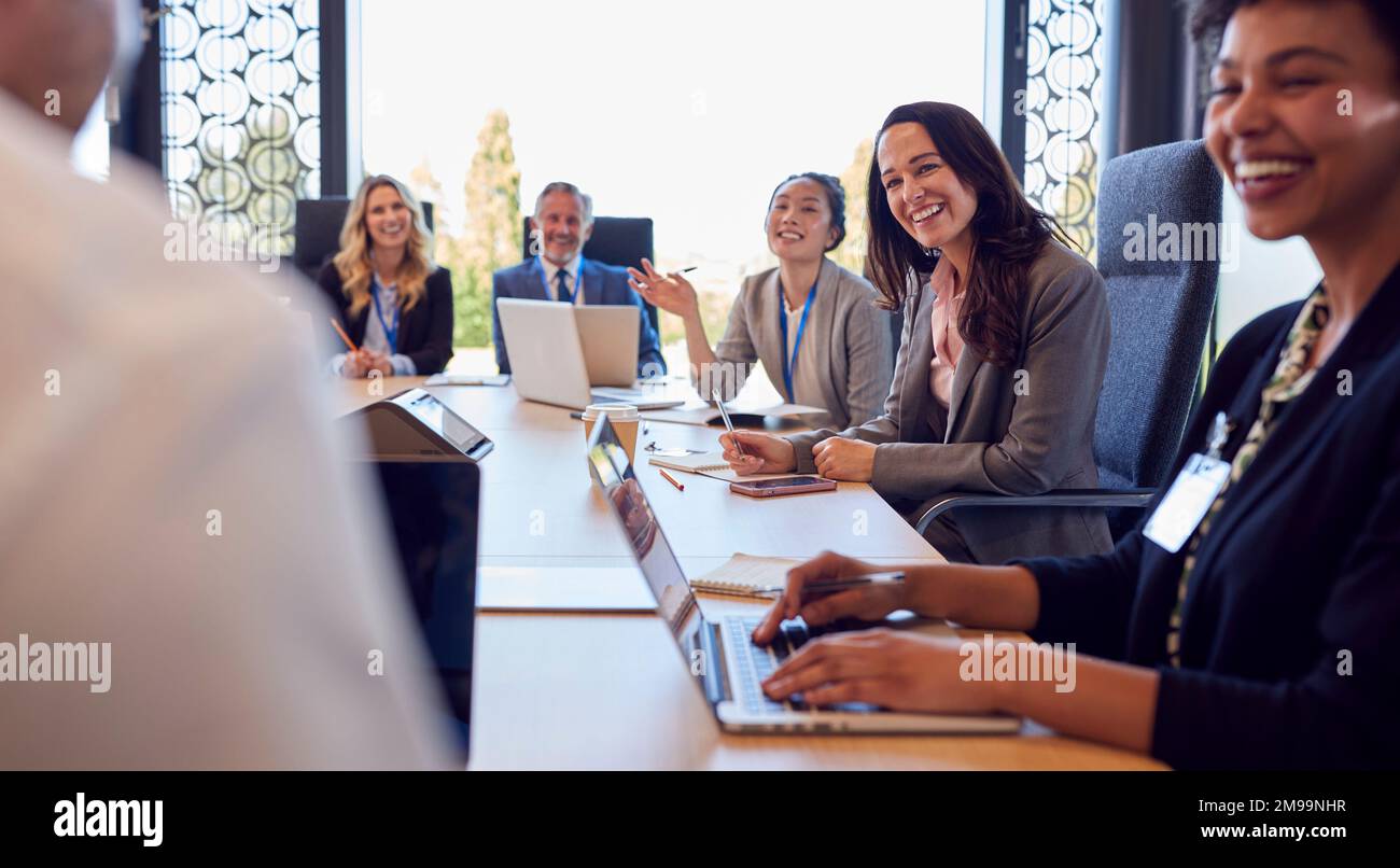 Multi-Cultural Business Team Meeting And Collaborating Around Table In ...