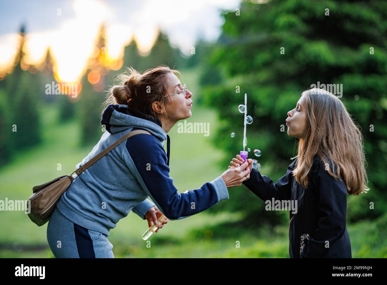 Happy kind caring mother and her cute smiling cheerful daughter with ...
