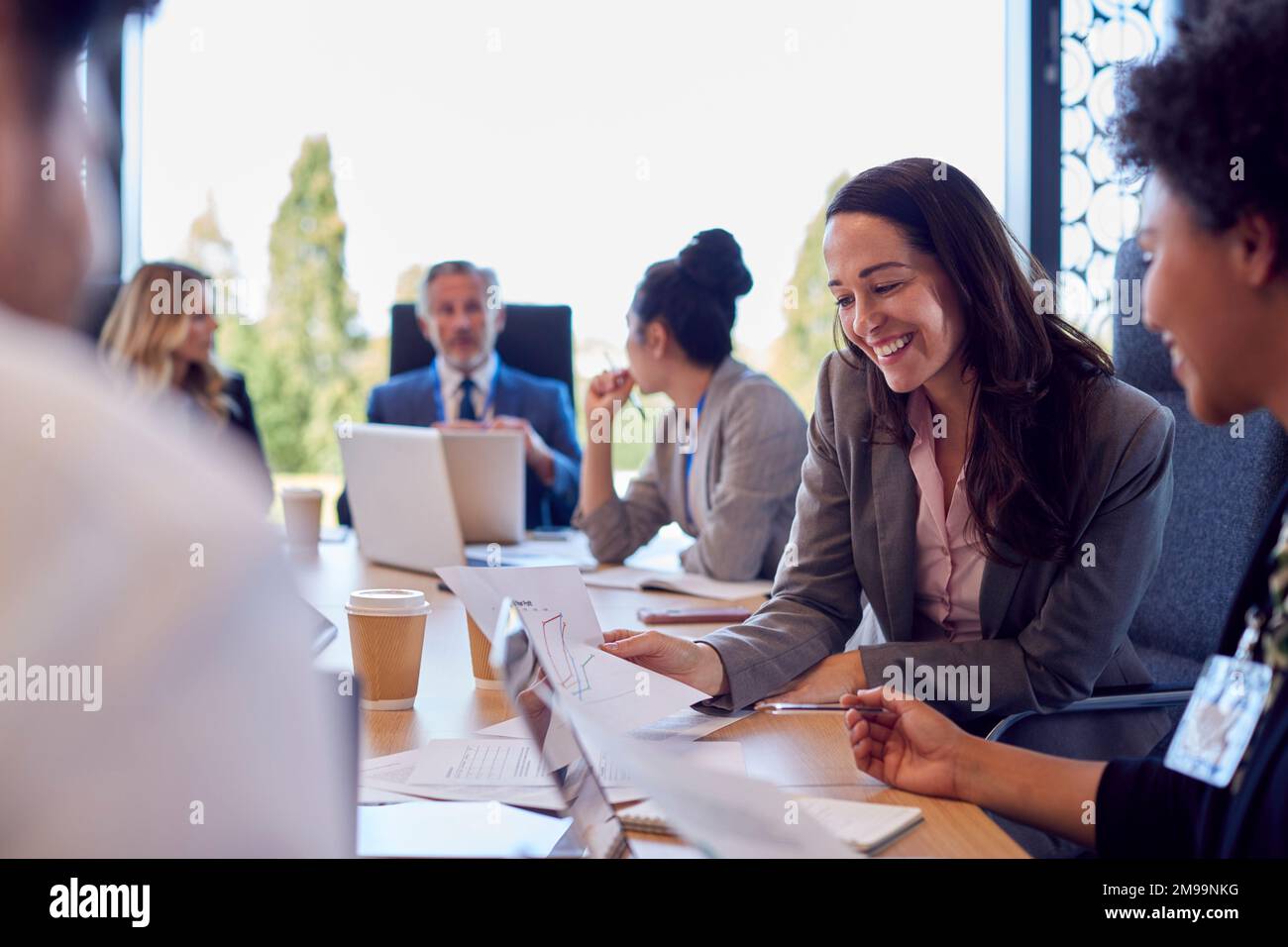 Multi-Cultural Business Team Meeting And Collaborating Around Table In ...