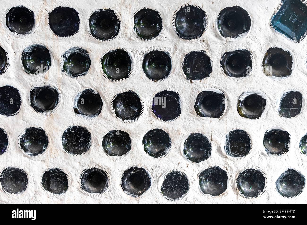 Decorative white walls with bottles set in concrete on Isla Holbox ...