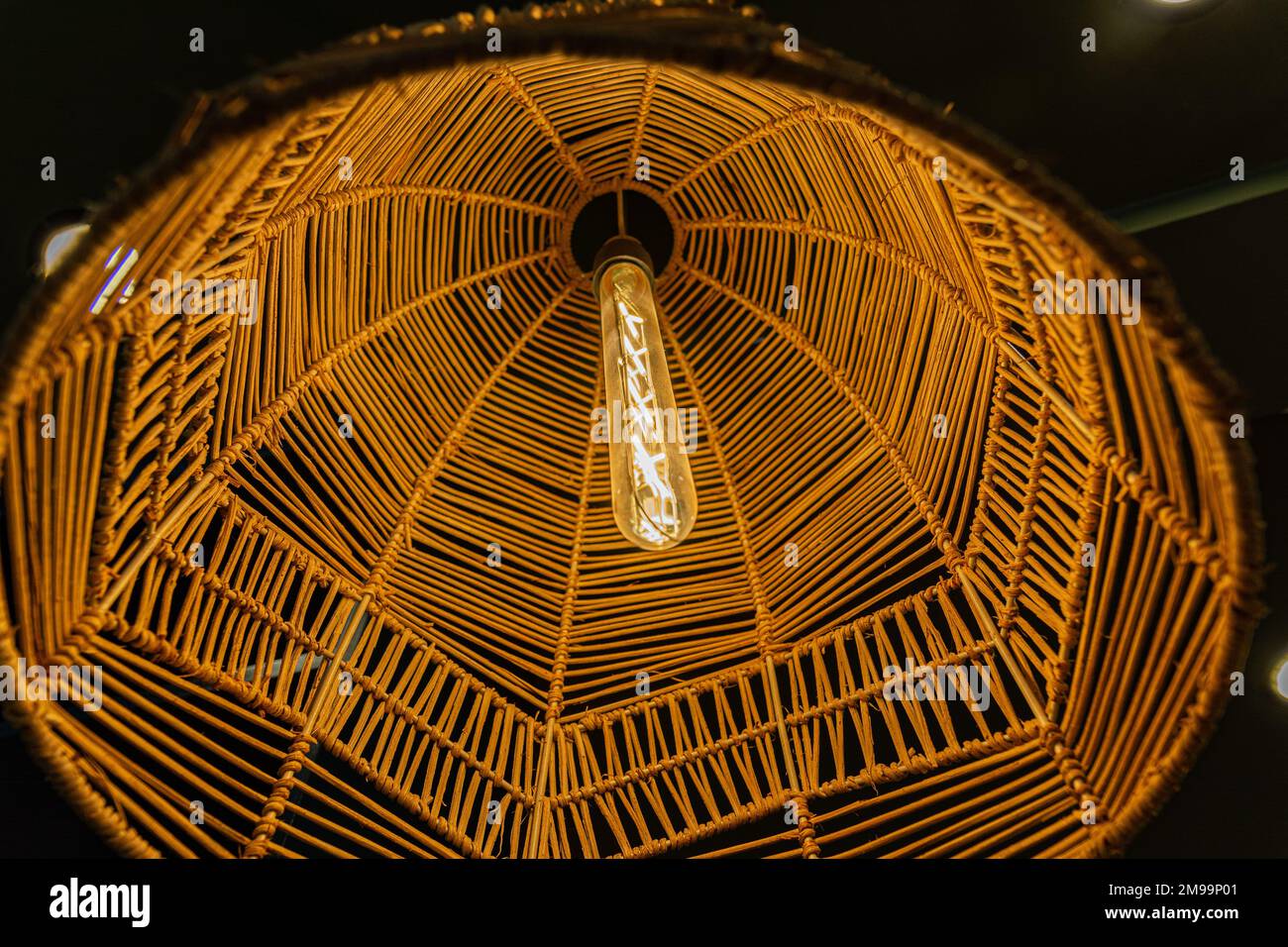 A lamp with a wicker wooden lampshade, beautiful bottom view. Cozy home ...