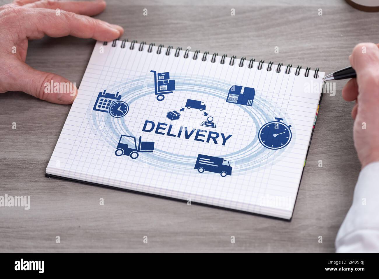 Hand holding a notepad with delivery concept Stock Photo - Alamy