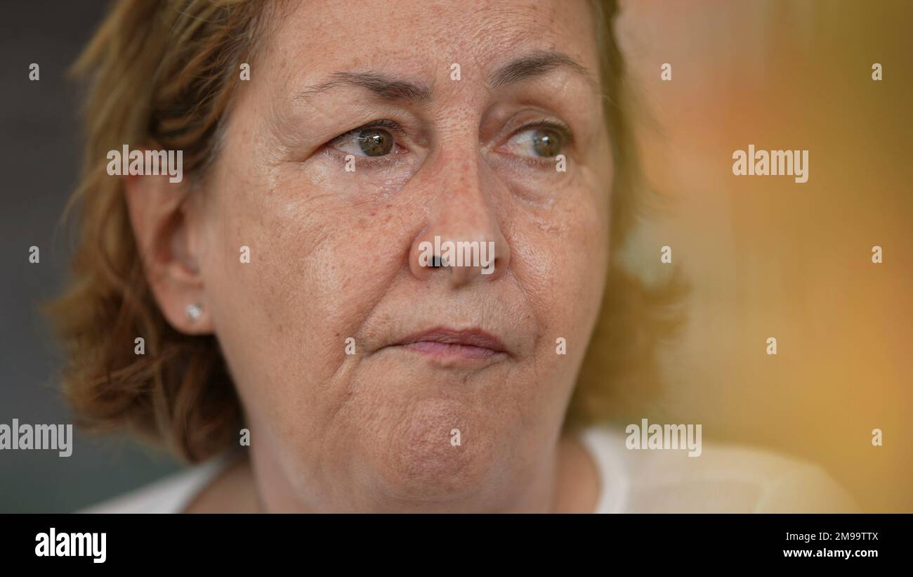 Pensive older woman thinking, thoughtful senior lady wondering lost in ...