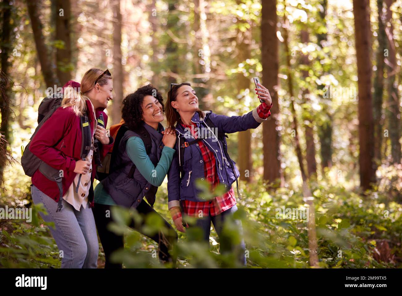 Female Friends Posing For Selfie On Mobile Phone On Holiday Hike ...