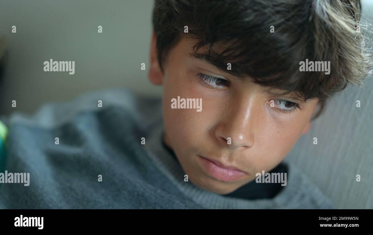 Pensive thoughtful young boy face close-up Stock Photo - Alamy