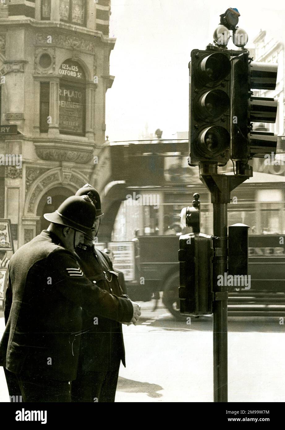 Traffic lights with bells on top, Oxford Street, London. The bells were ...
