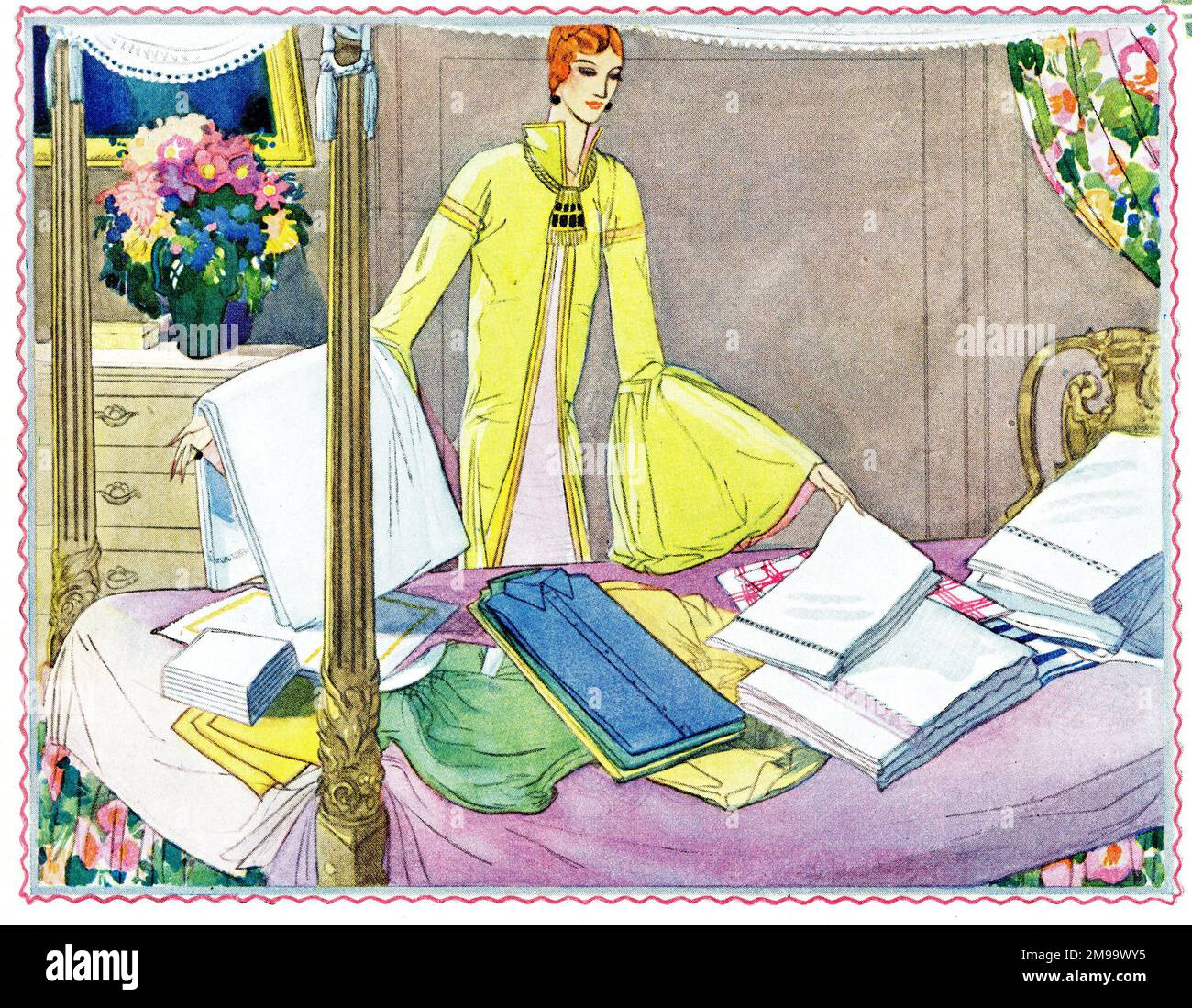 Woman sorting out laundry on four poster bed Stock Photo - Alamy