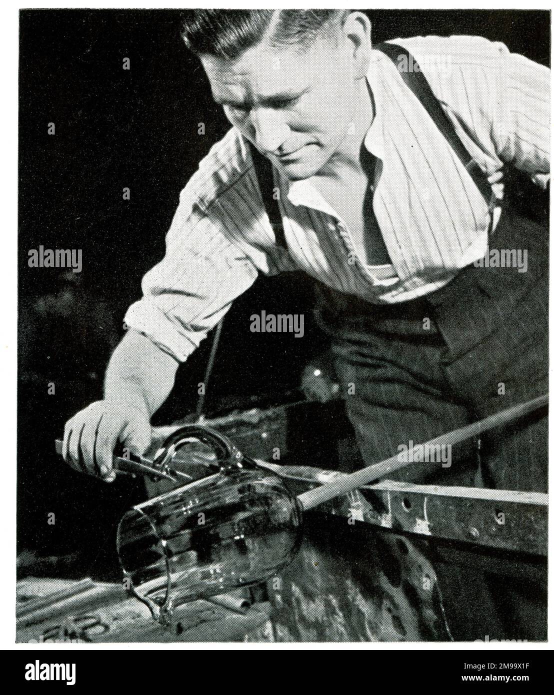 Glass blower fixing a handle on a jug Stock Photo - Alamy