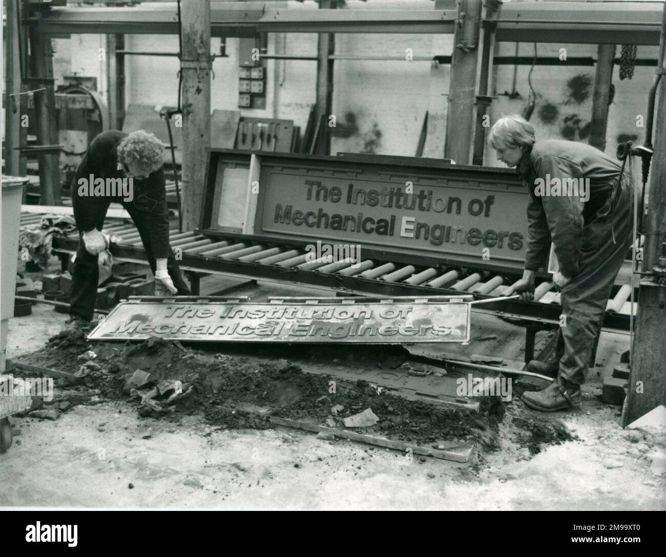 Photograph of the casting of a name plate for a locomotive named 'The ...