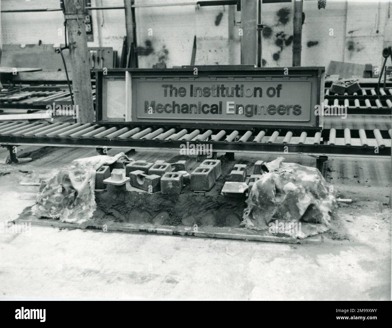 Photograph of the casting of a name plate for a locomotive named 'The ...