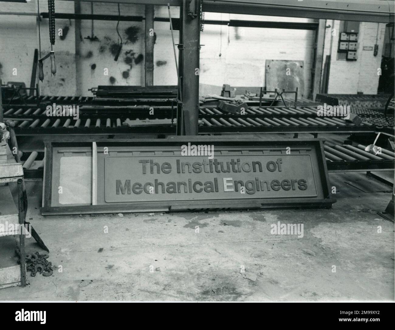 Photograph of the casting of a name plate for a locomotive named 'The ...