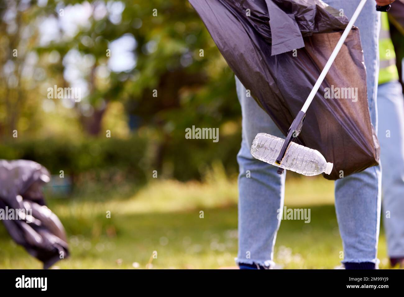 Close Up Of Female Volunteers Picking Up Litter In The Countryside ...