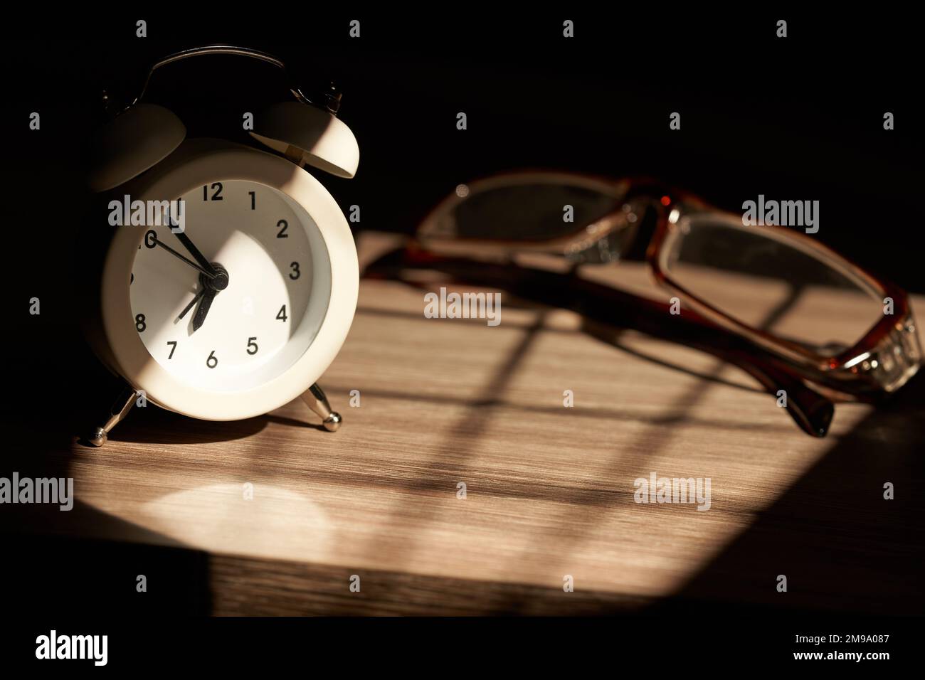 A retro style alarm clock on wooden background Stock Photo - Alamy
