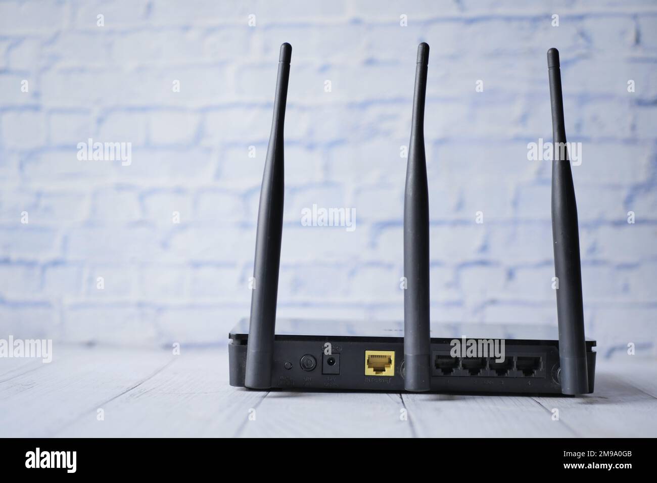 Wi-Fi router with cables on table Stock Photo - Alamy