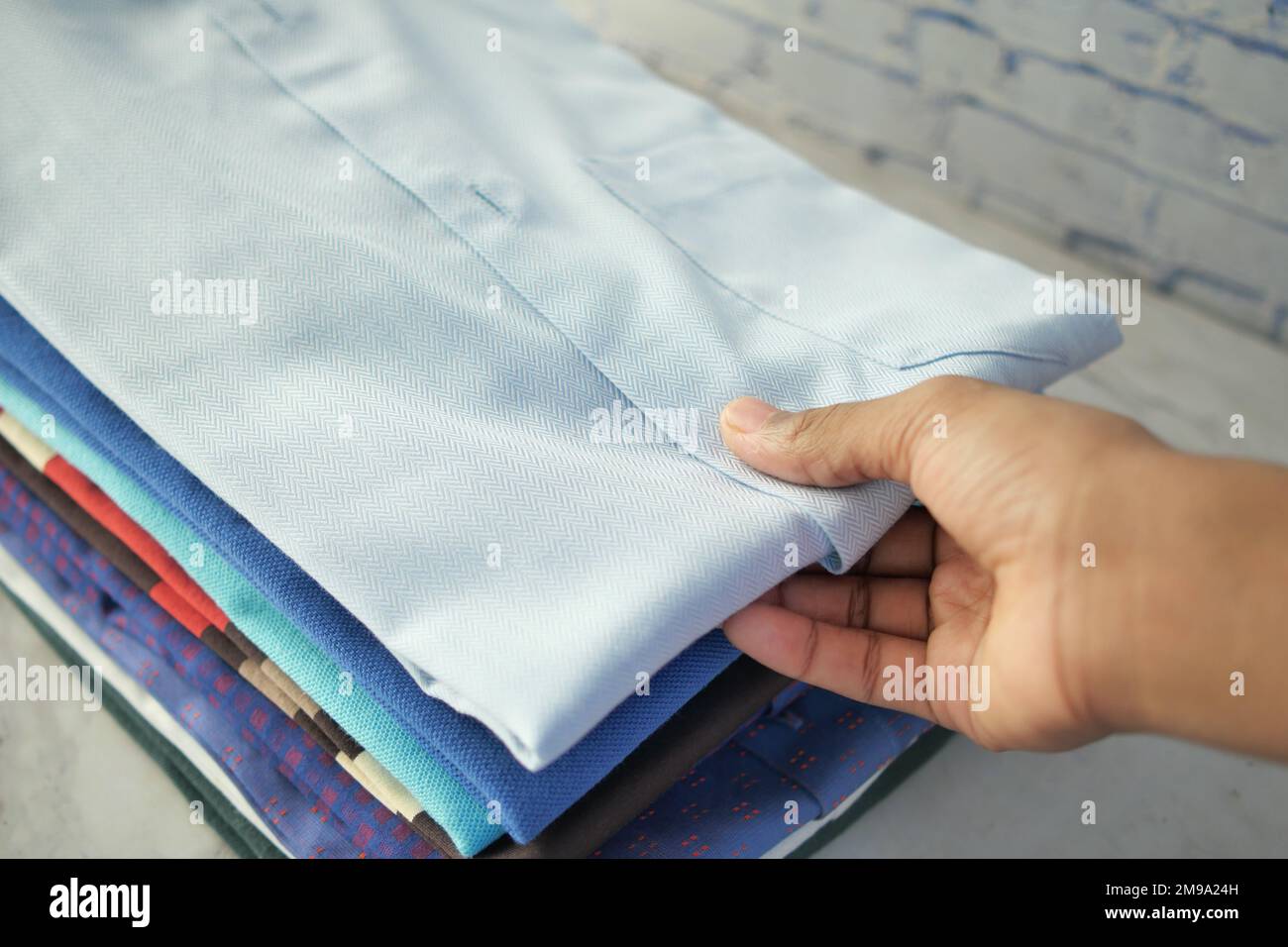 Putting on new shirts hi-res stock photography and images - Alamy
