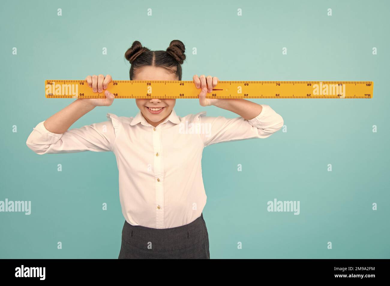 Measuring school equipment. Schoolgirl holding measure for geometry ...