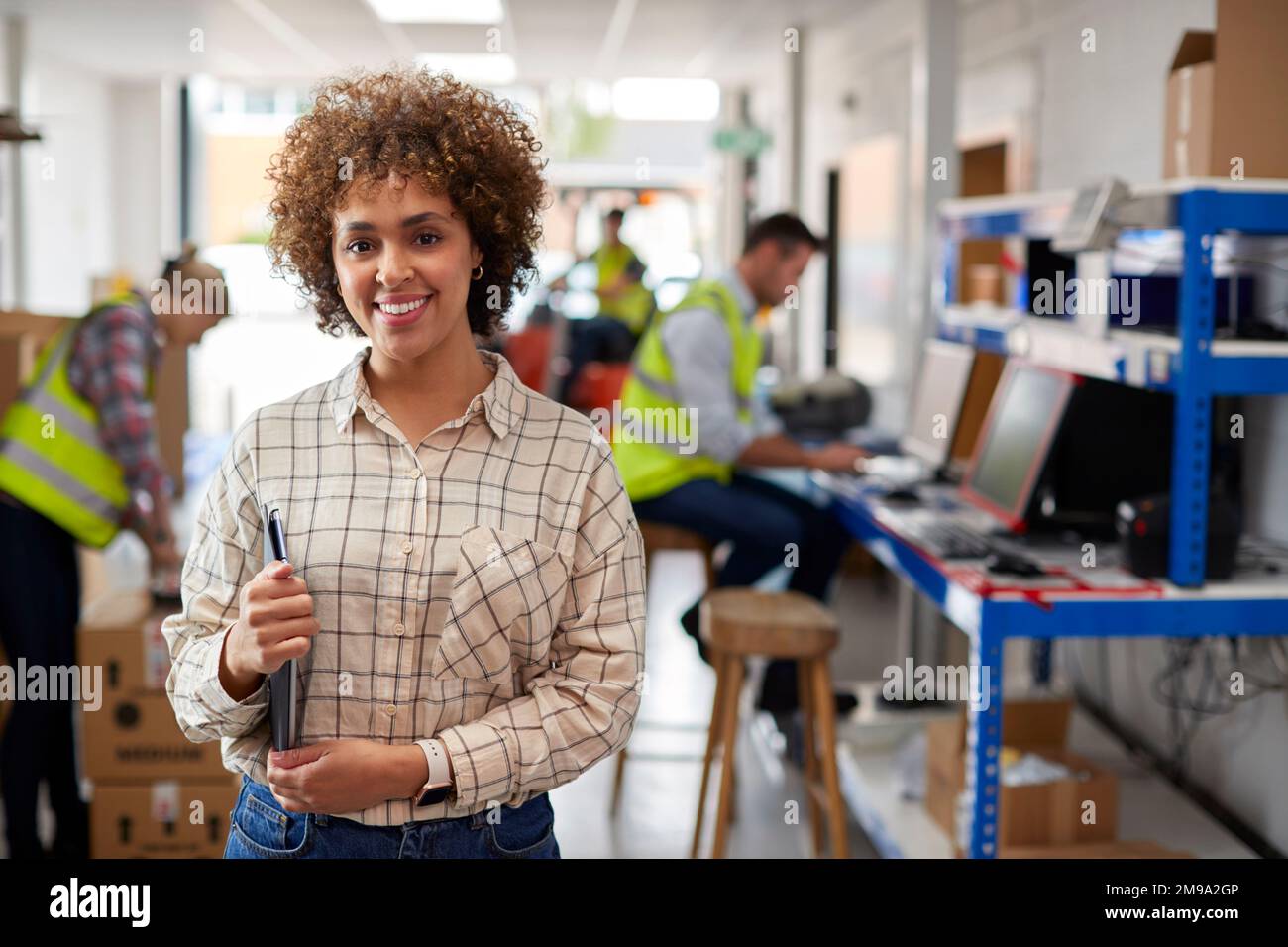 Portrait Of Female Manager In Logistics Distribution Warehouse Using ...