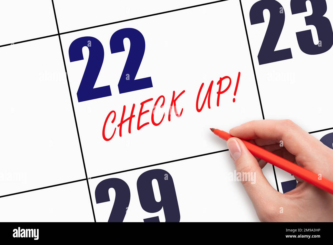 22nd day of the month. Hand writing text CHECK UP on calendar date ...