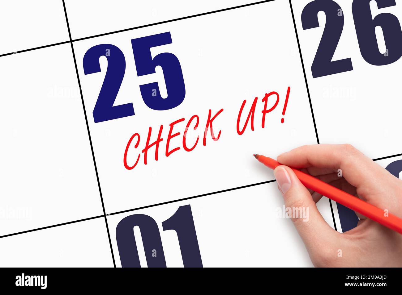 25th day of the month. Hand writing text CHECK UP on calendar date ...