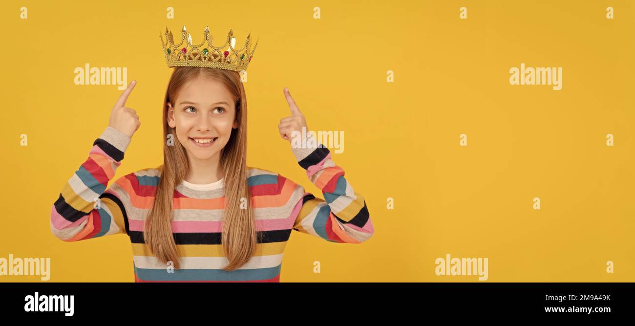 happy teen kid point finger on queen crown on yellow background. Child ...